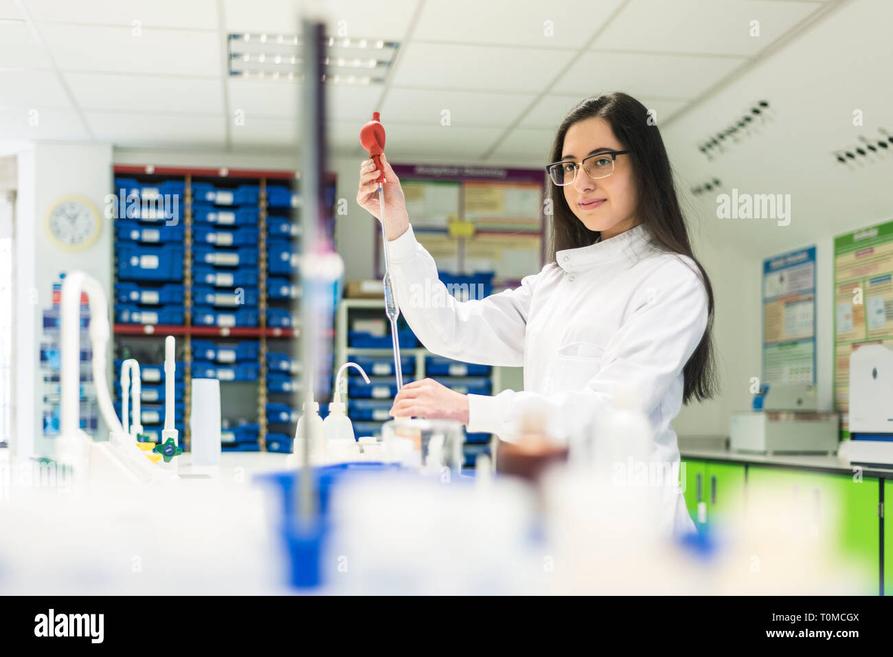 a young asian female student working in the science lab of a cambridge ...