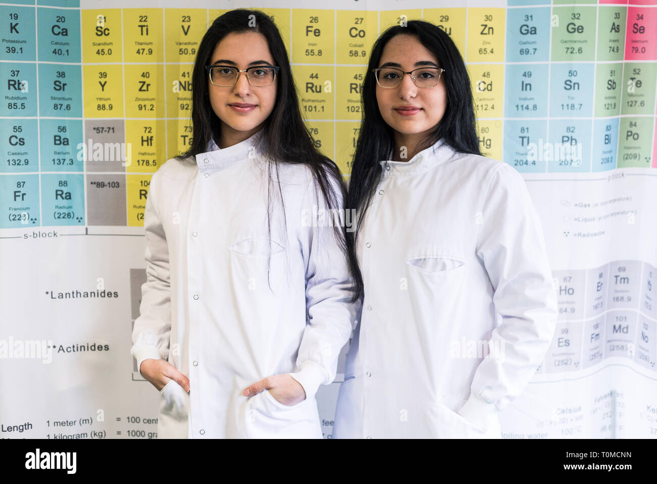 two twin sisters who are studying science in college in cambridge carry ...