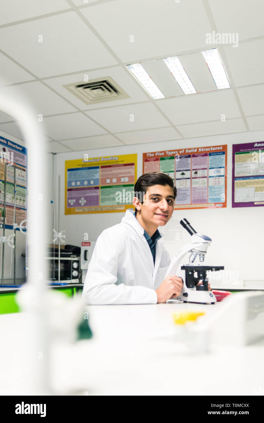 A young male student works in the science lab of a cambridge college in ...