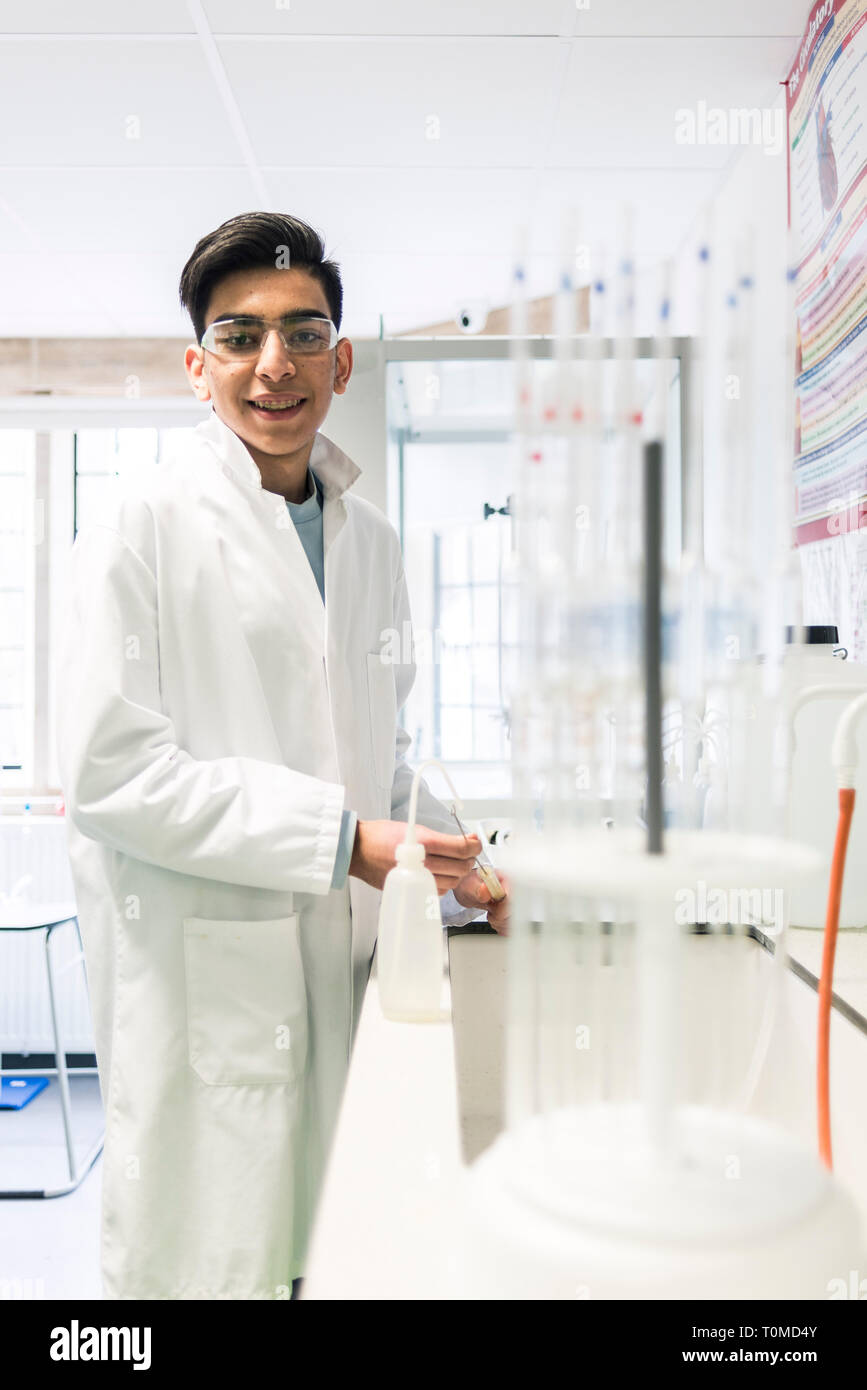 A young male student works in the science lab of a cambridge college in ...