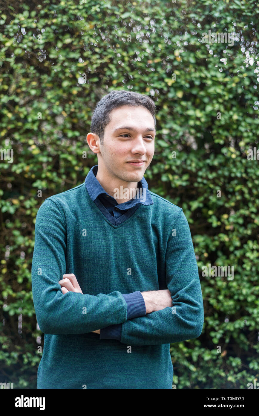 A middle eastern young male college student relaxes in the communal ...