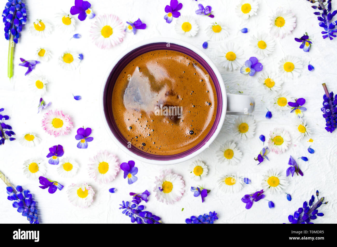 Coffee cup and fresh spring flowers on white background flat lay Stock ...