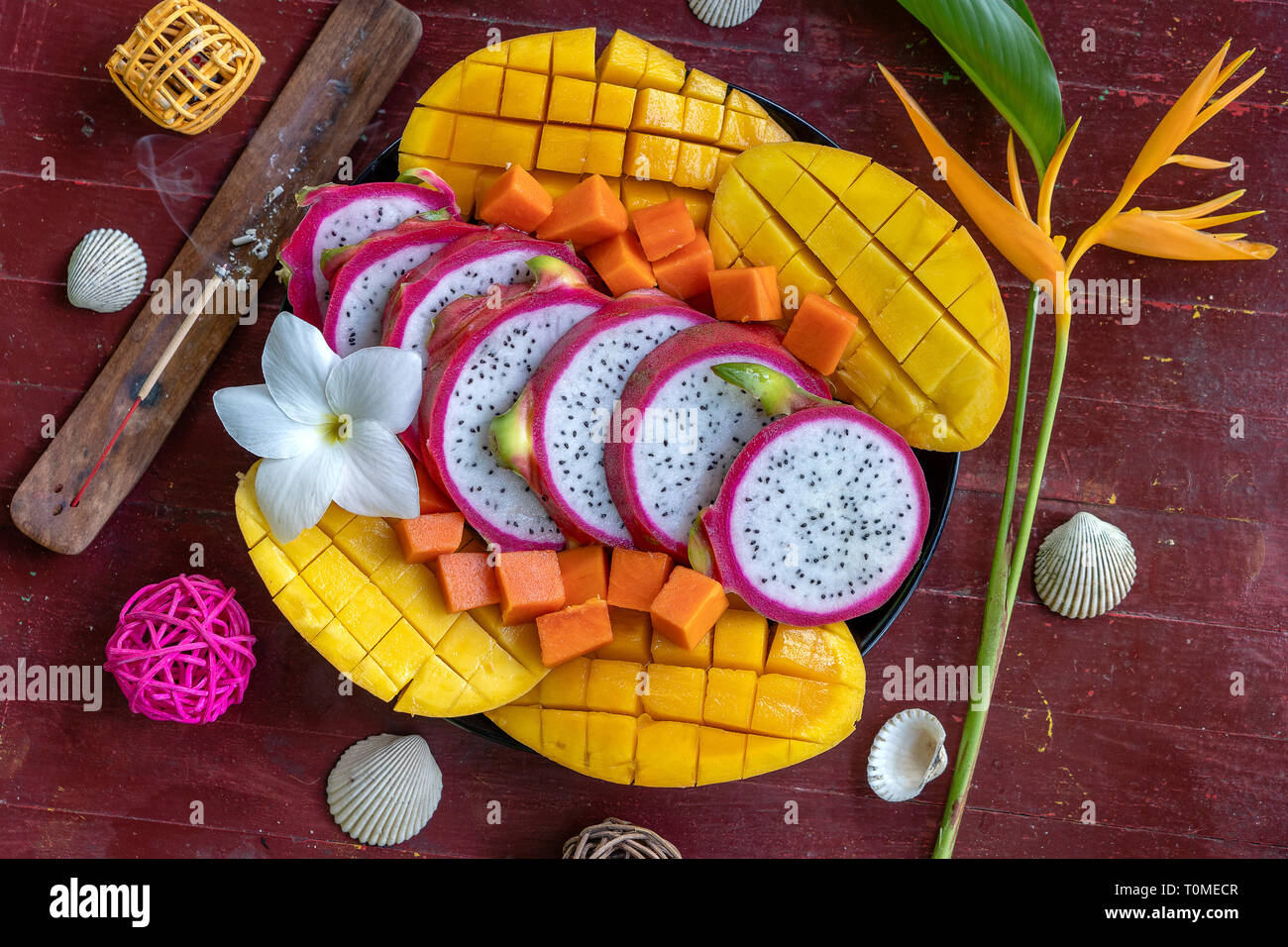 Tropical fruits assortment on a plate, close up. Many colorful ripe ...