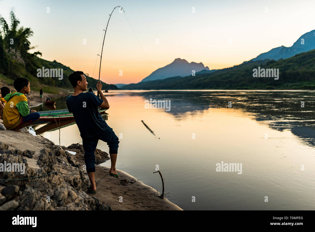 Fishing on the Mekong at sunset, Laos Stock Photo - Alamy