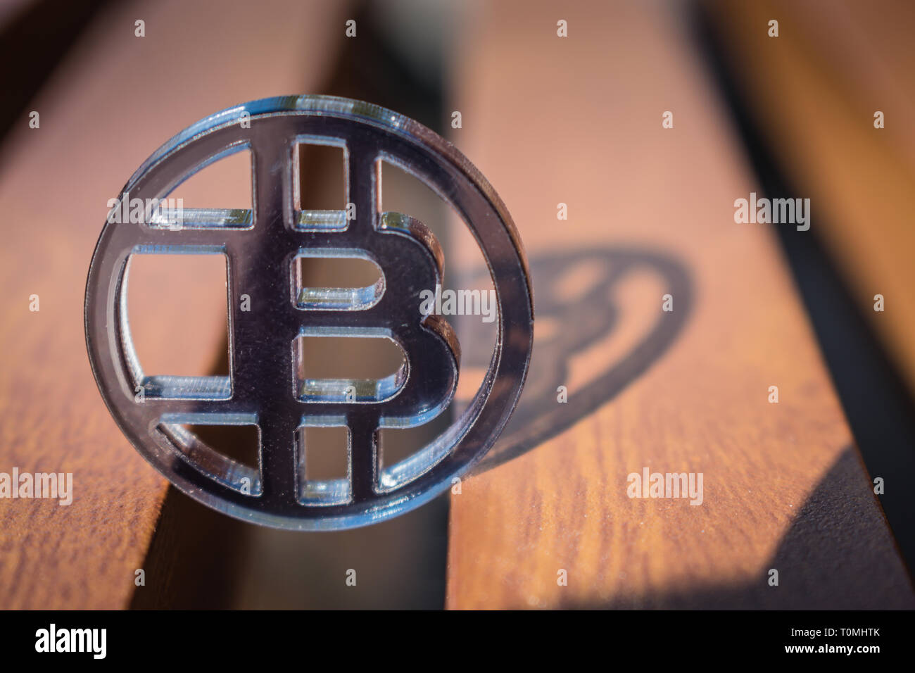 Plastic see thru bit coin on wooden background and lines Stock Photo ...