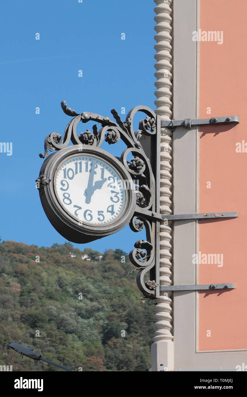 Hours on building wall. Como, Italy Stock Photo - Alamy
