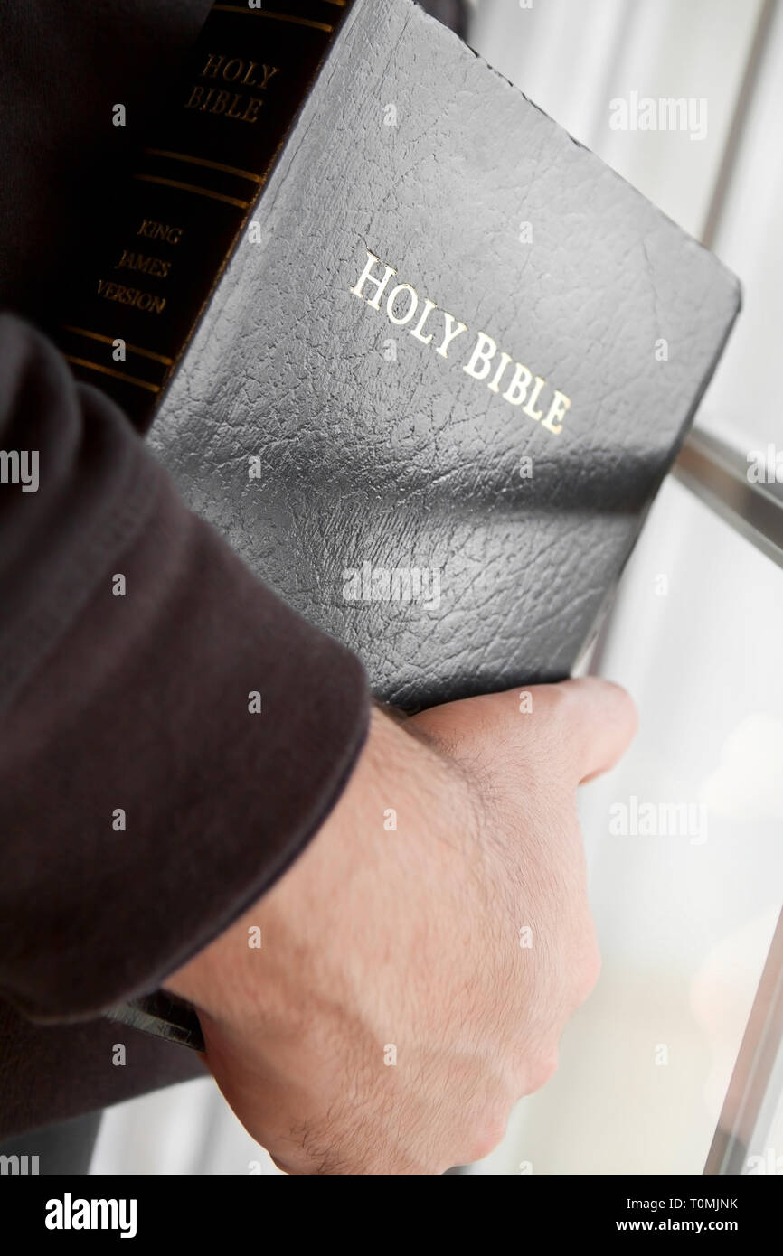 Male holding bible hi-res stock photography and images - Alamy