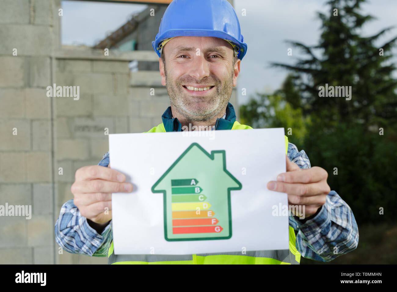 laborer showing energy rating sign Stock Photo - Alamy