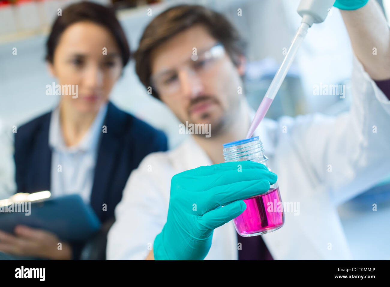 pharmacy biotechnologist demonstrating sample Stock Photo - Alamy