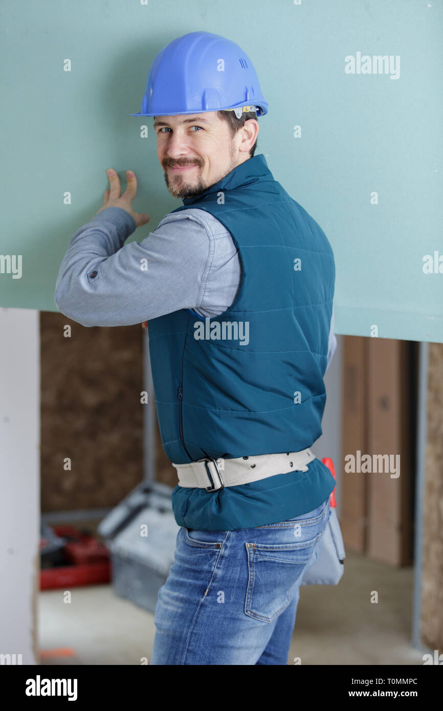 builder carrying blocks indoors Stock Photo - Alamy