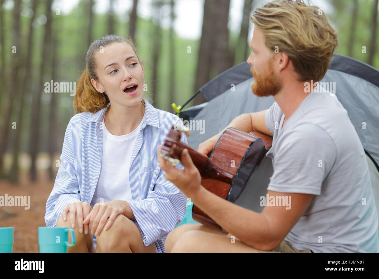young couple singing outside the tent Stock Photo - Alamy