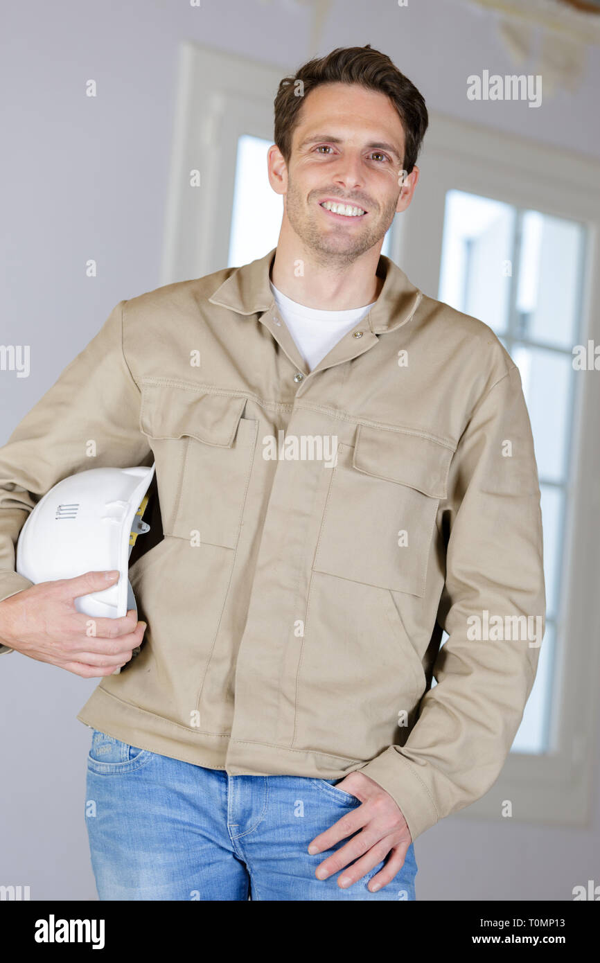 portrait of builder stood inside a property Stock Photo - Alamy