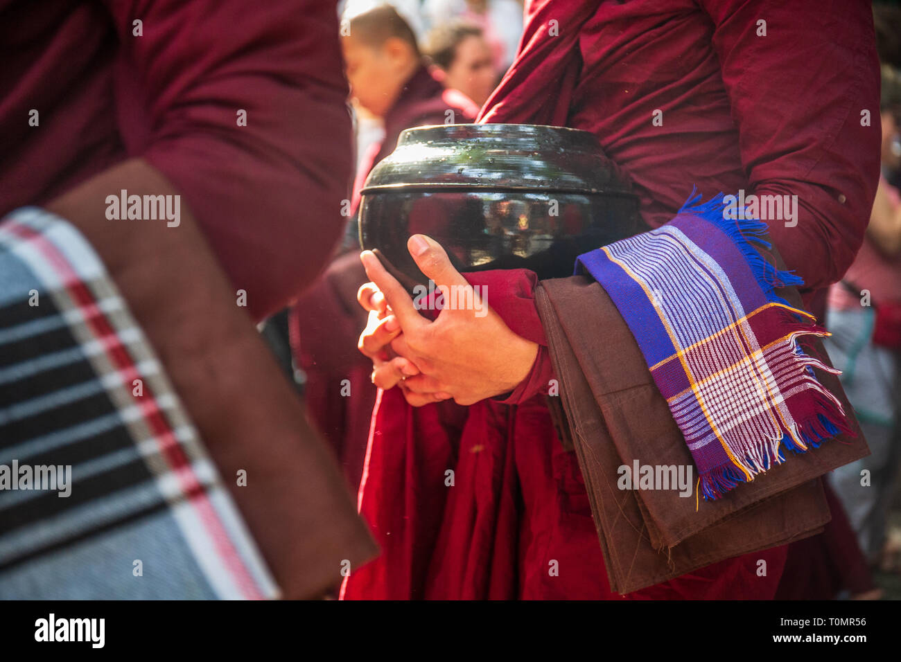 Monk hands holding bowl in the Mahagandayon monastery Stock Photo - Alamy