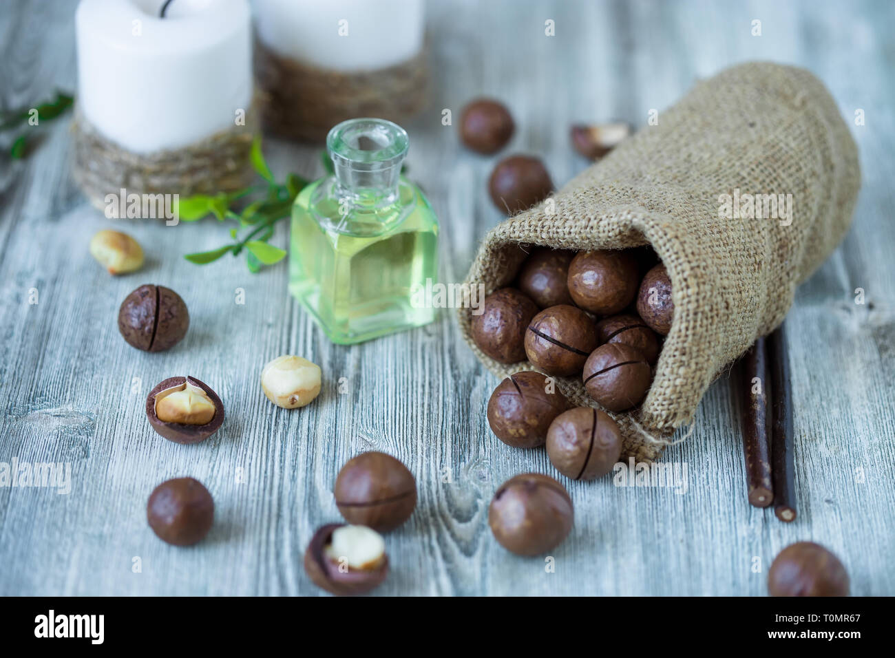 Macadam nuts, walnut oil, on wooden background. Relax, health care ...