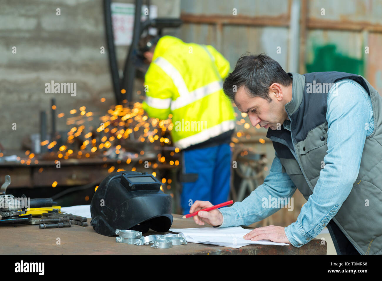 welding supervisor checking the design Stock Photo - Alamy