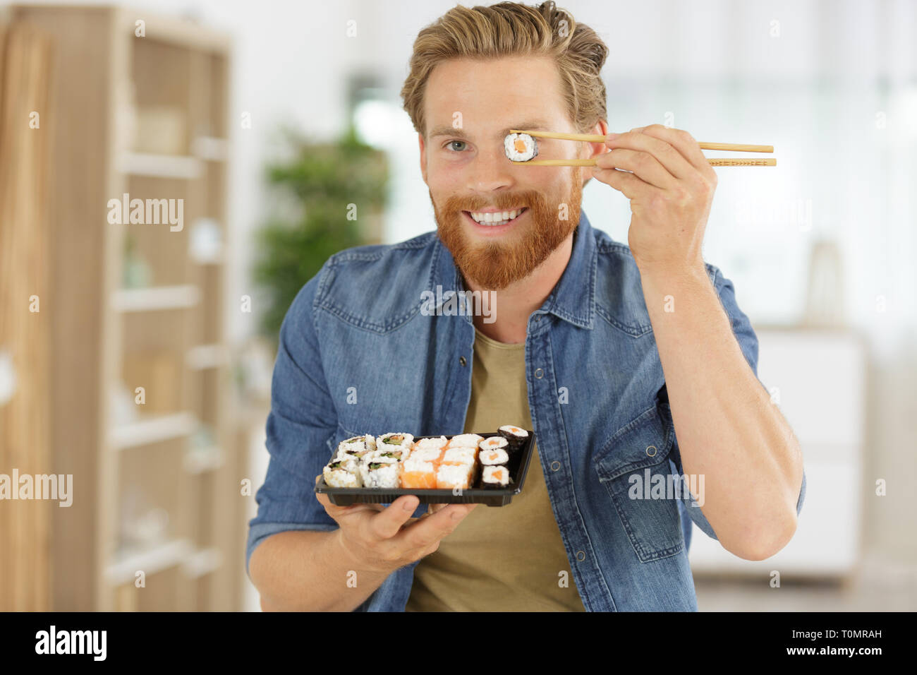 man having fun with sushi Stock Photo - Alamy