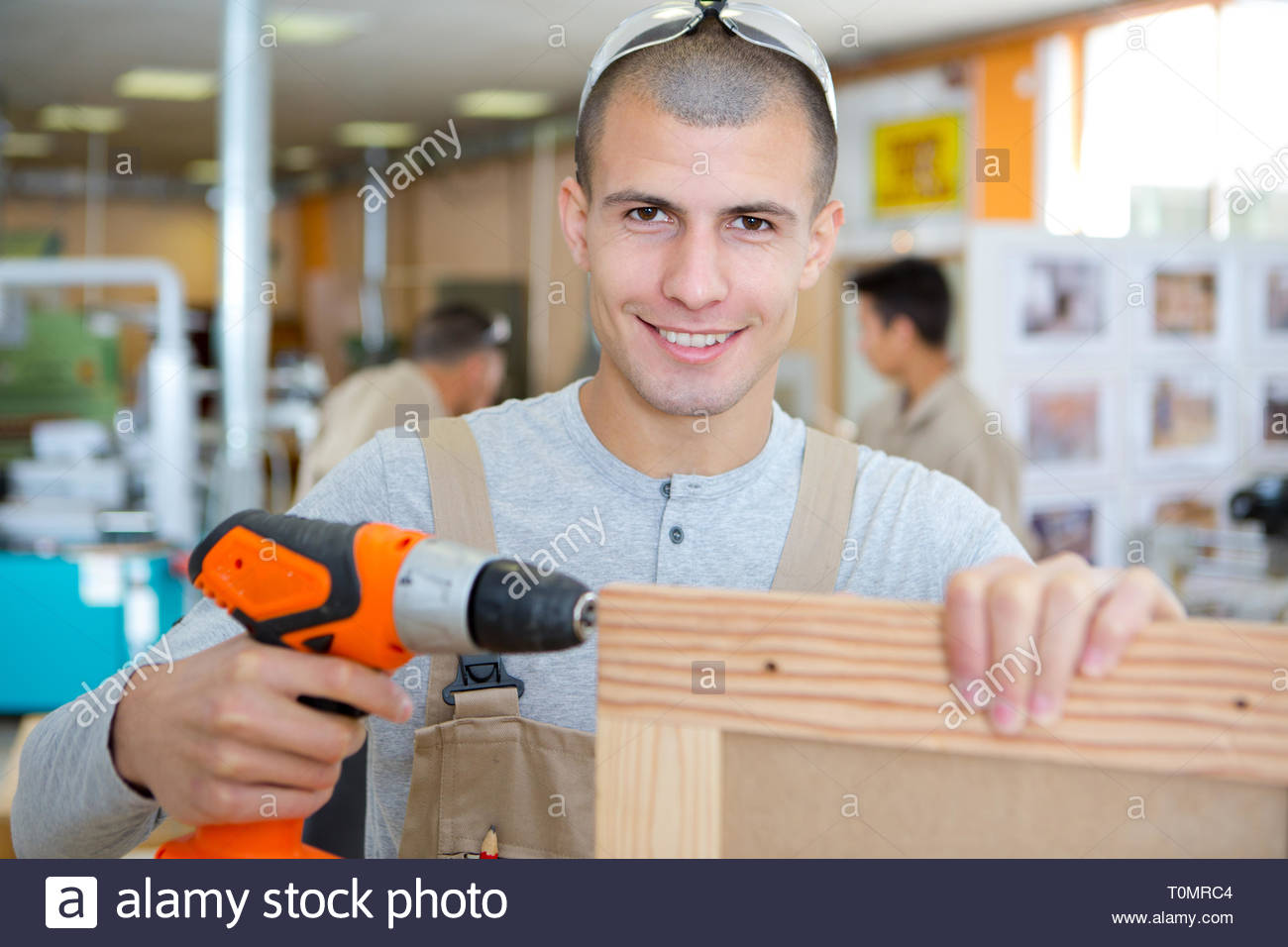 woodworking frame worker posing holding drill Stock Photo - Alamy