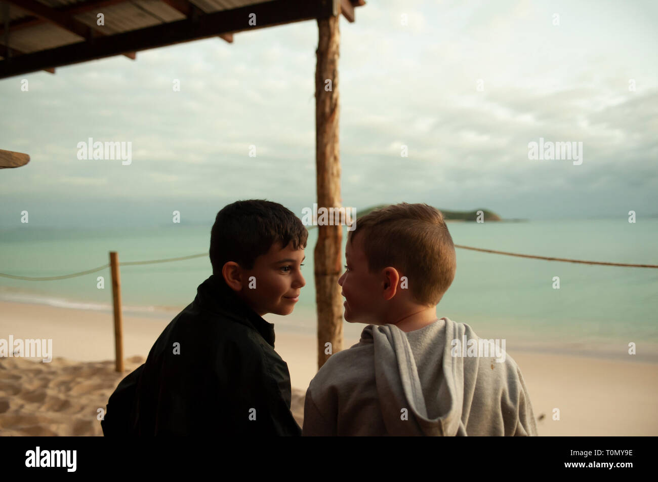 9 year old and 7 year old boys outside a lean to beach hut on Putney ...