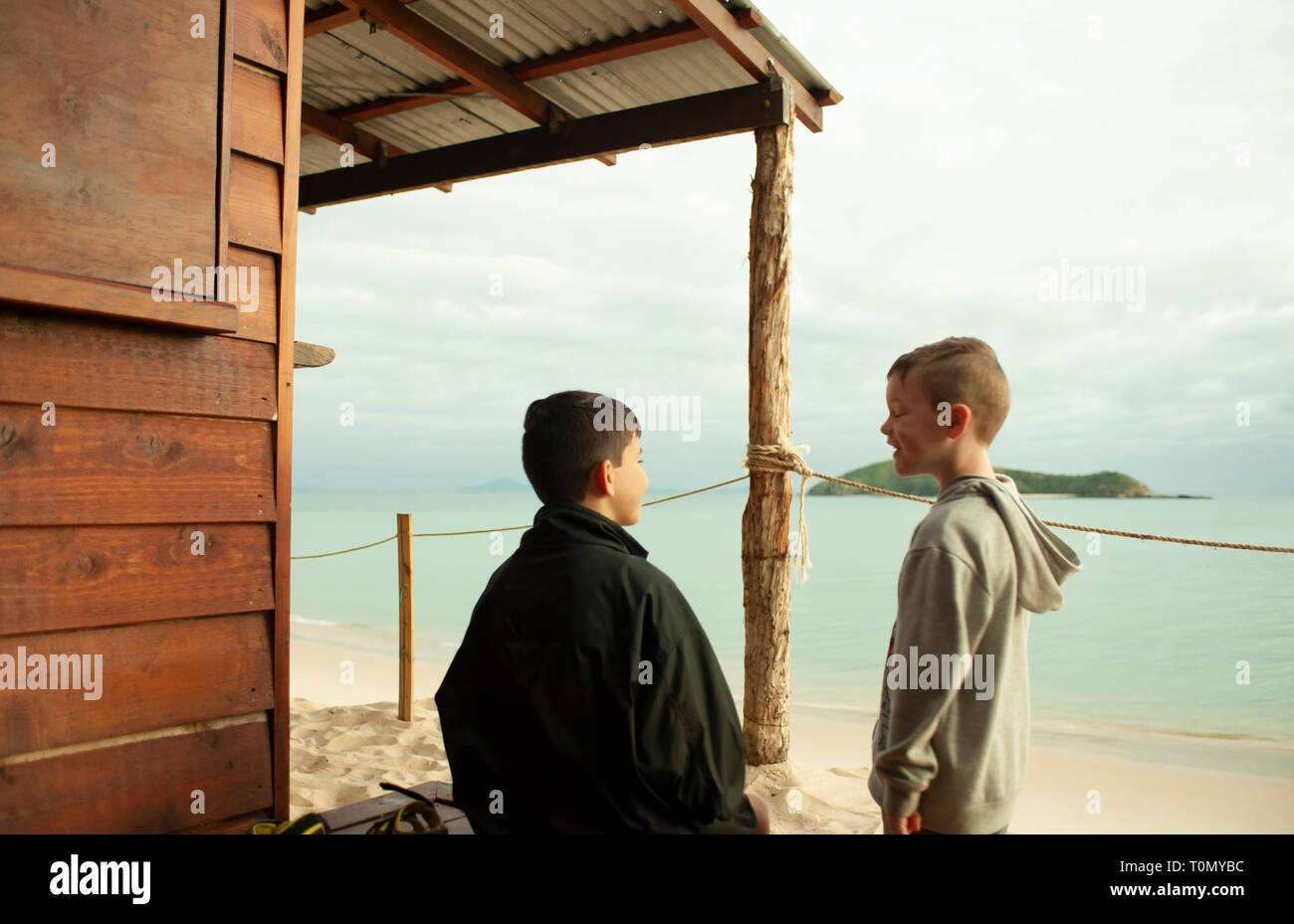 9 year old and 7 year old boys outside a lean to beach hut on Putney ...