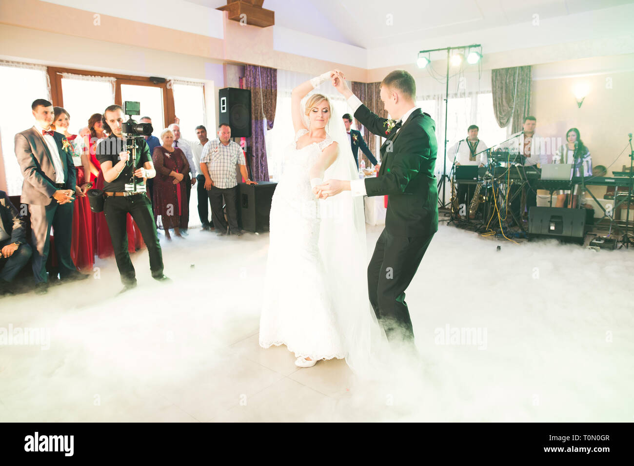 Beautiful caucasian wedding couple just married and dancing their first ...
