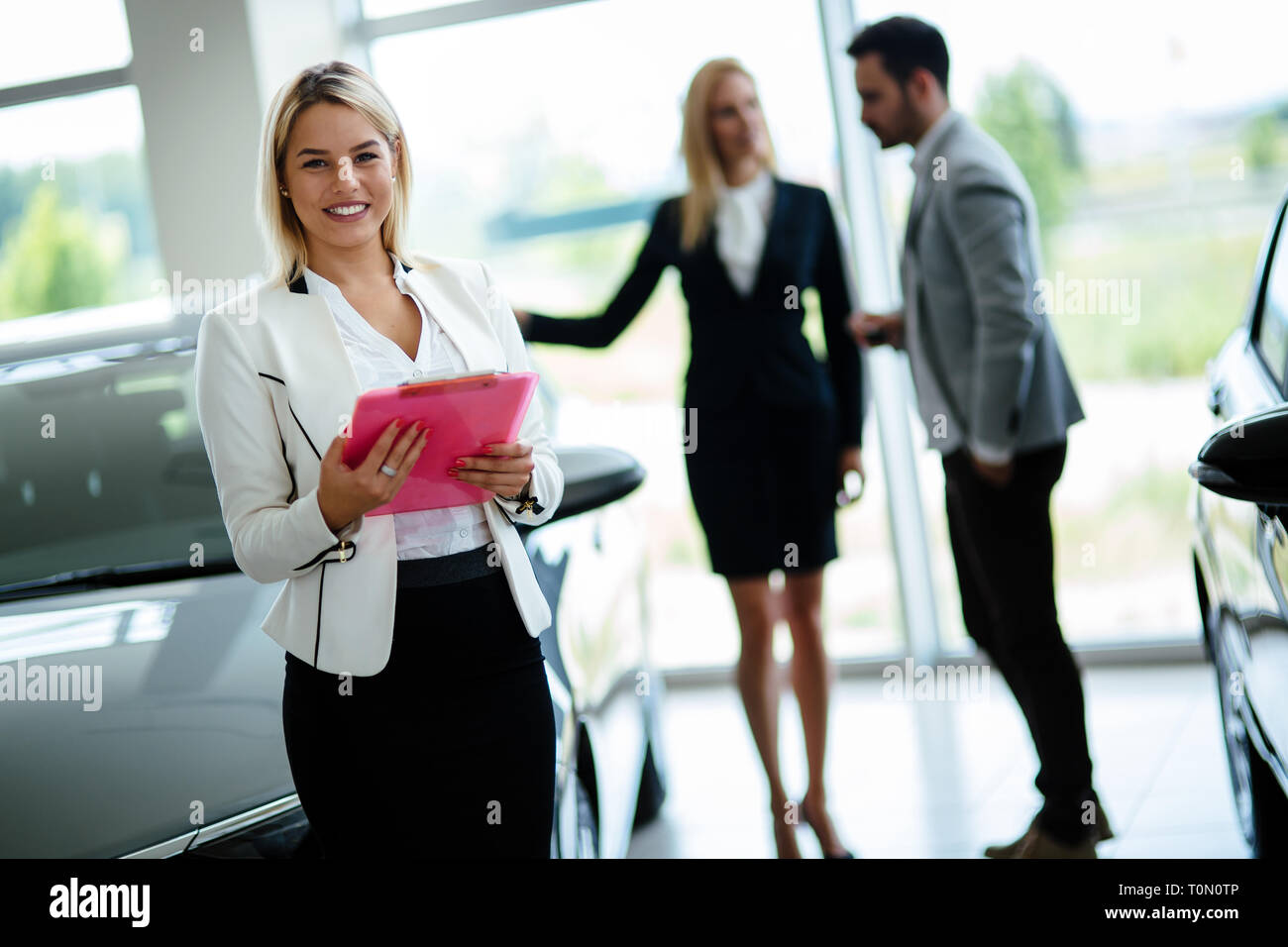 Picture of attractive saleswoman working in company Stock Photo - Alamy