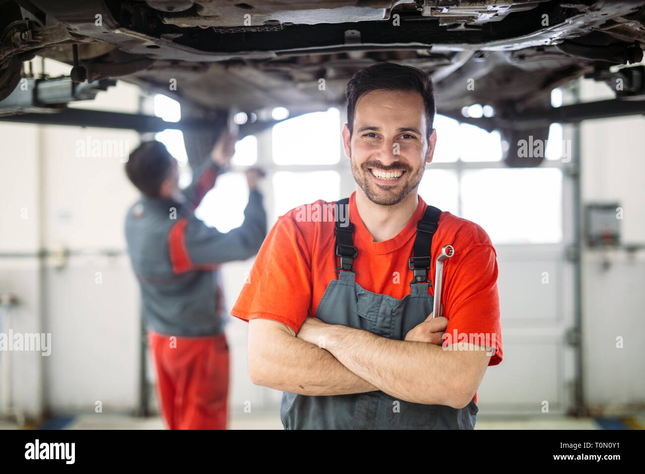 Auto mechanic working in garage. Repair service Stock Photo - Alamy