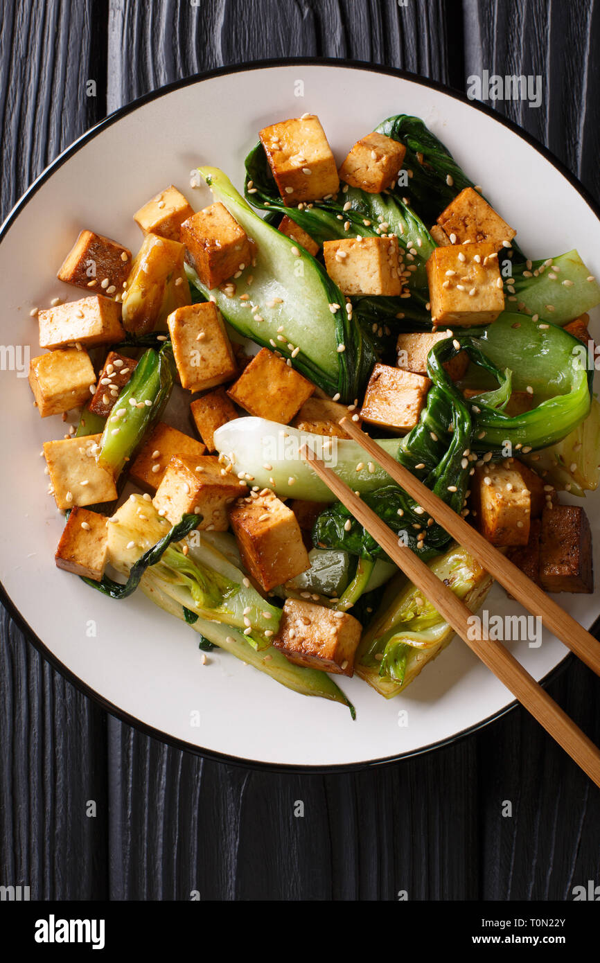 Asian veggie fried tofu with bok cho and sesame close-up on a plate on ...