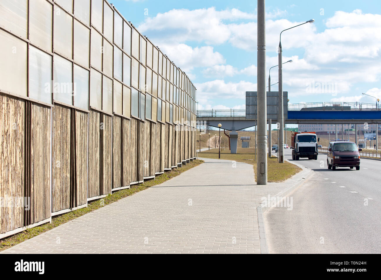 Sound absorbing panels along freeway in city. Concept of protecting ...