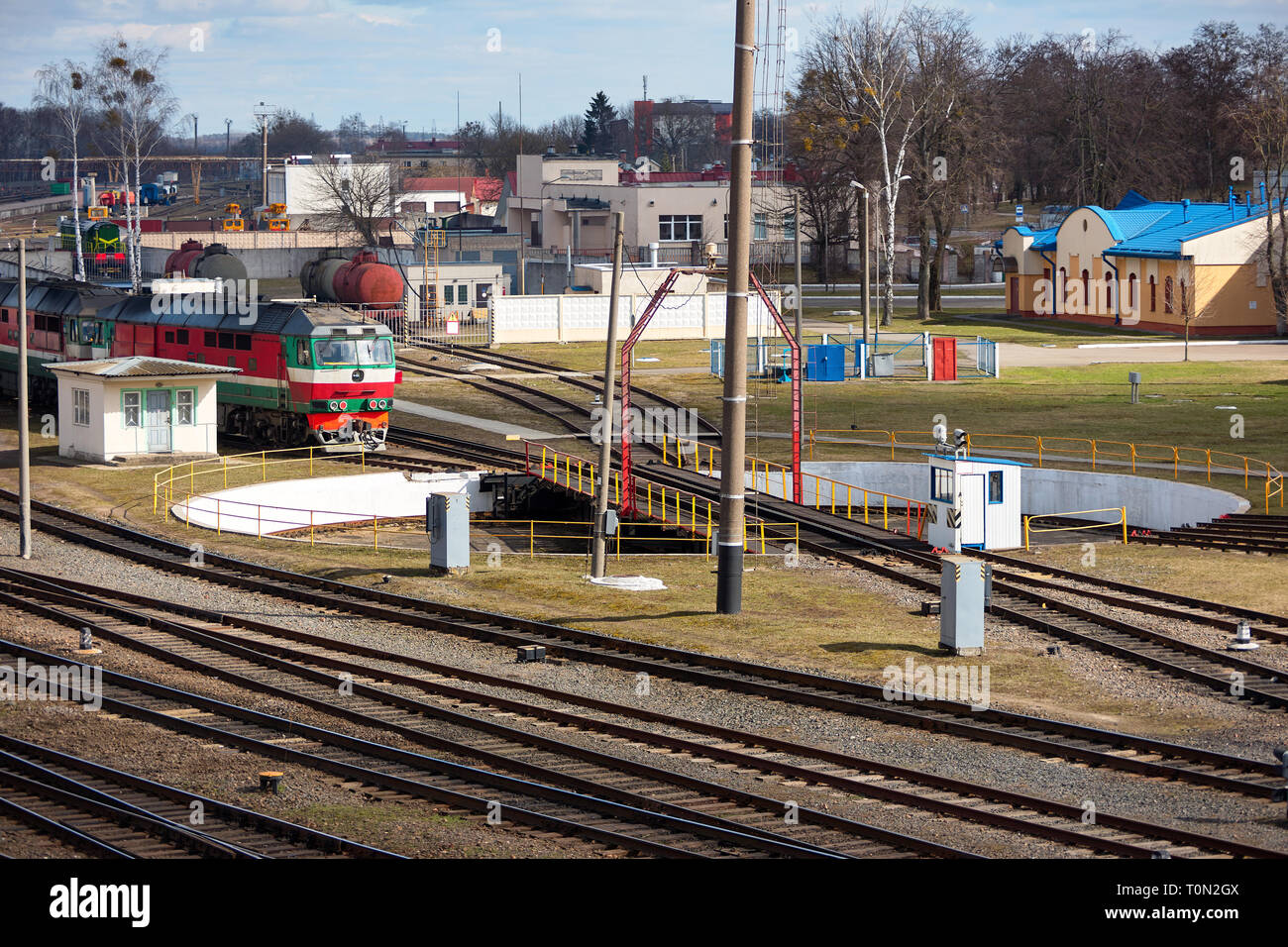 Diesel locomotive at entrance to railway turntable in railway depot on ...
