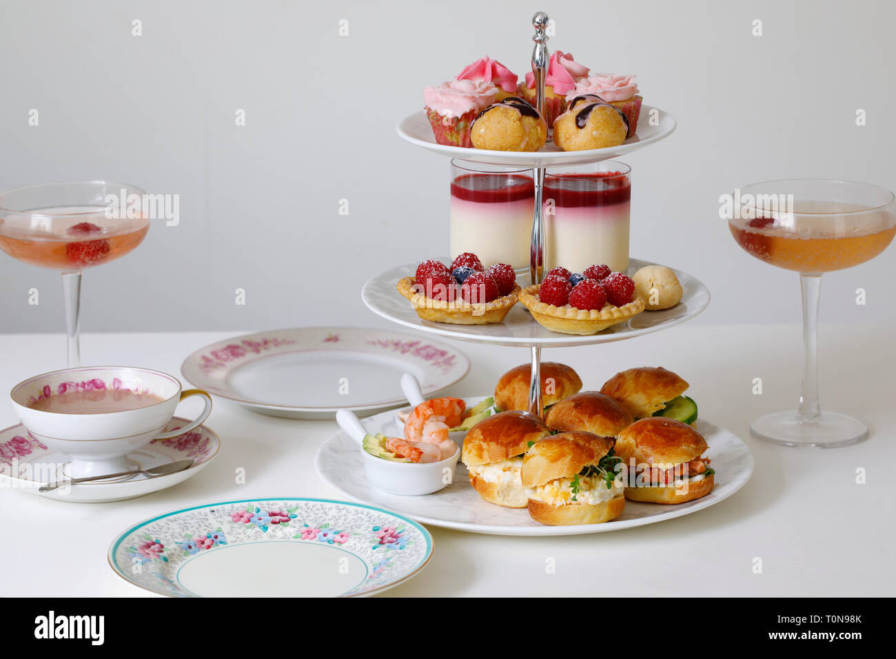 Afternoon tea with mini brioche canapes and selection of sweets Stock ...