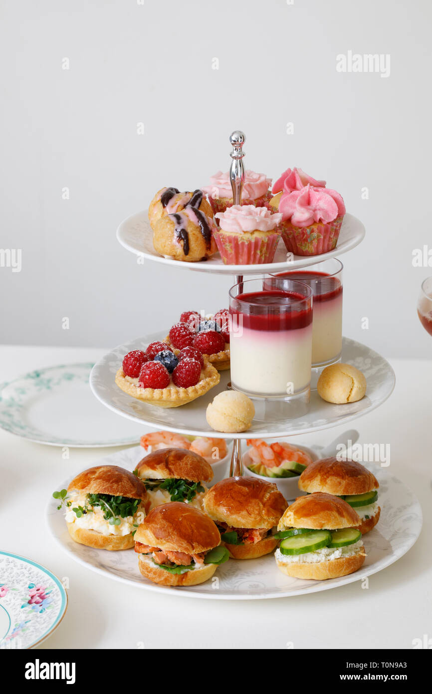 Afternoon tea with mini brioche canapes and selection of sweets Stock ...