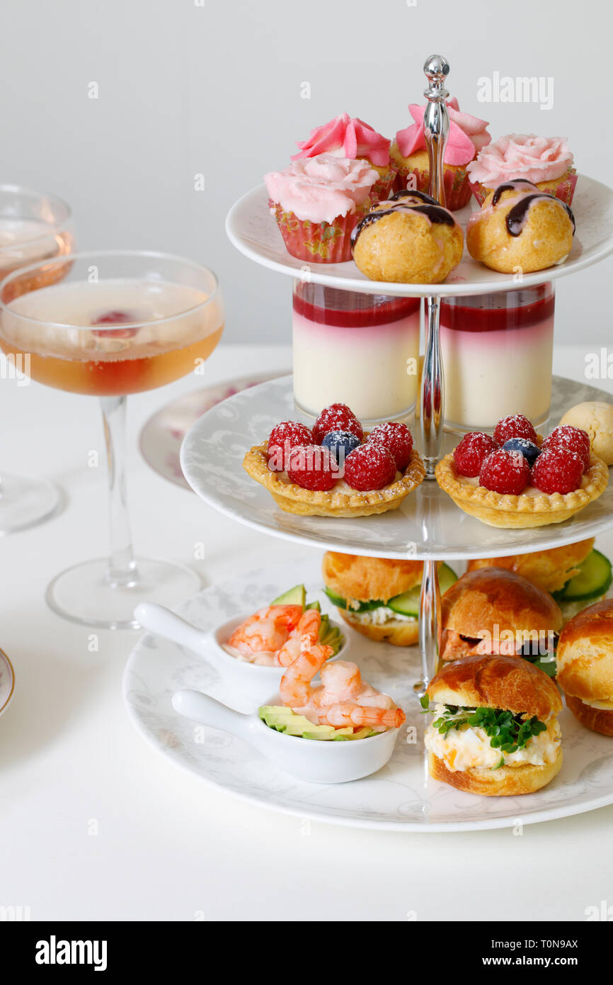 Afternoon tea with mini brioche canapes and selection of sweets Stock ...