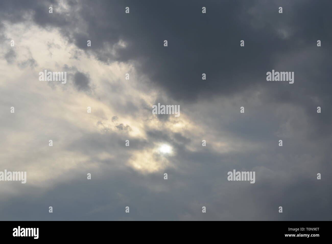 rain cloud hide the sun on dull sky Stock Photo - Alamy