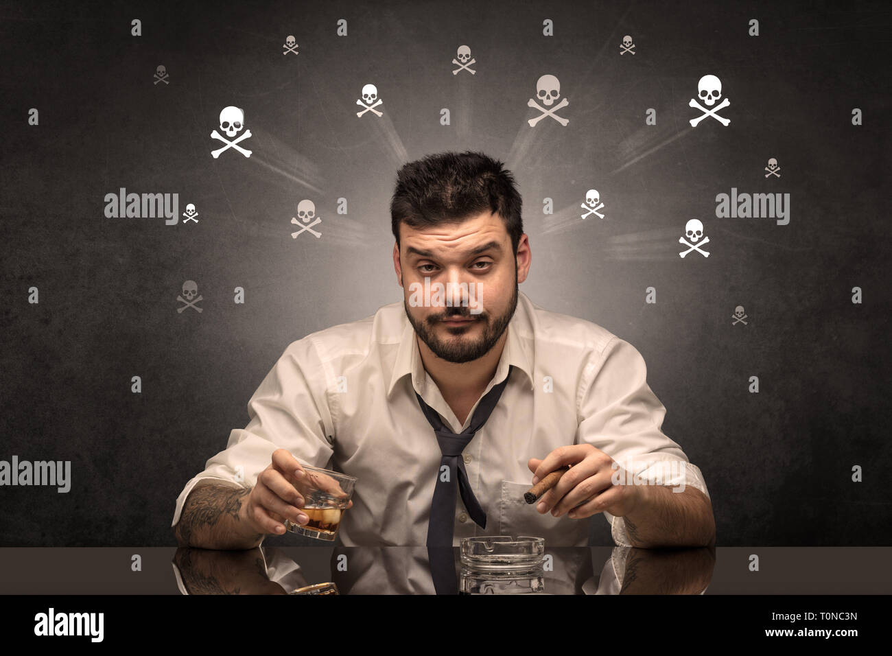 Loser drunk man sitting at table with skulls concept around Stock Photo ...