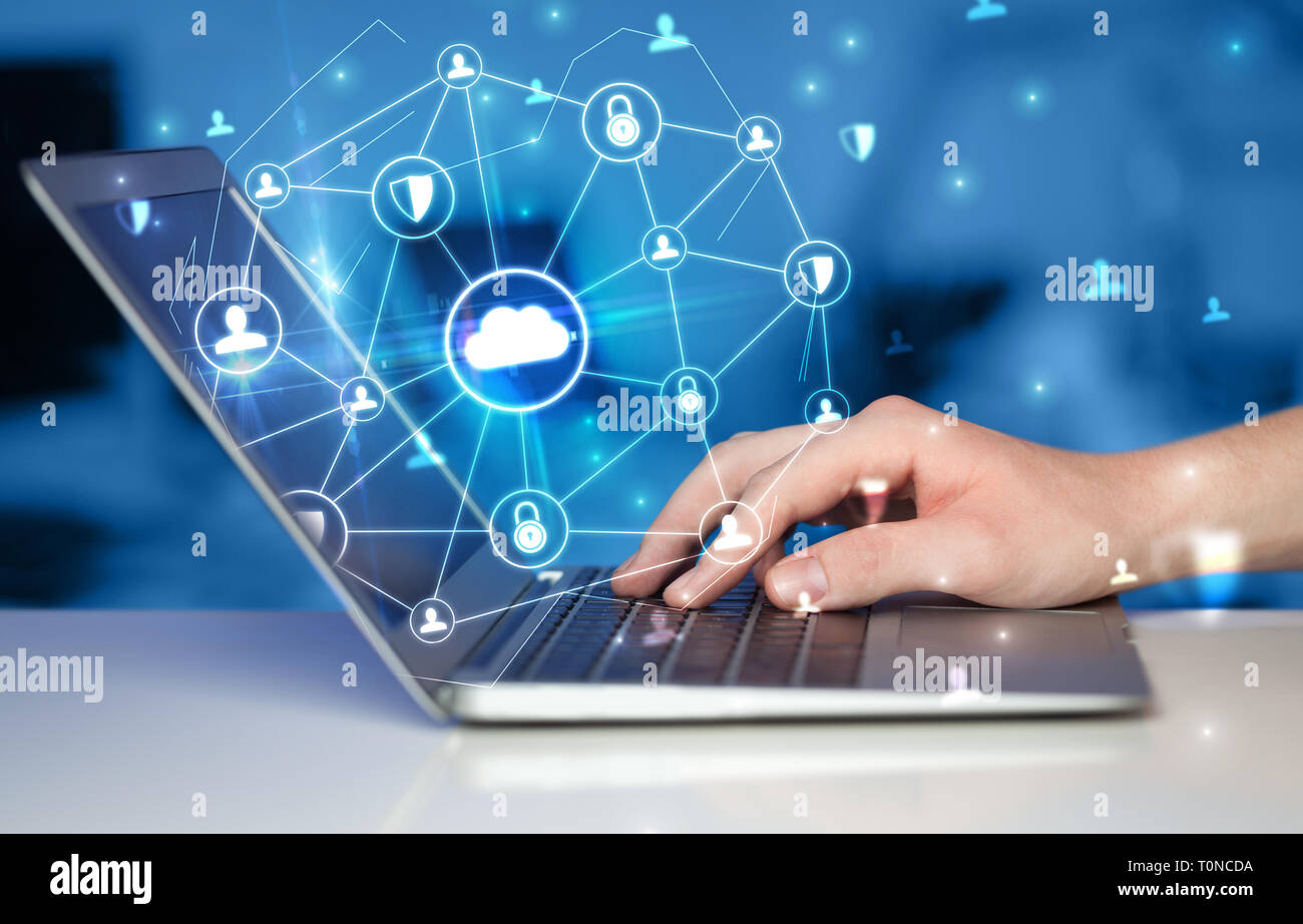 Hand Using Laptop With Centralized Cloud Computing System And Network Security Concept Stock