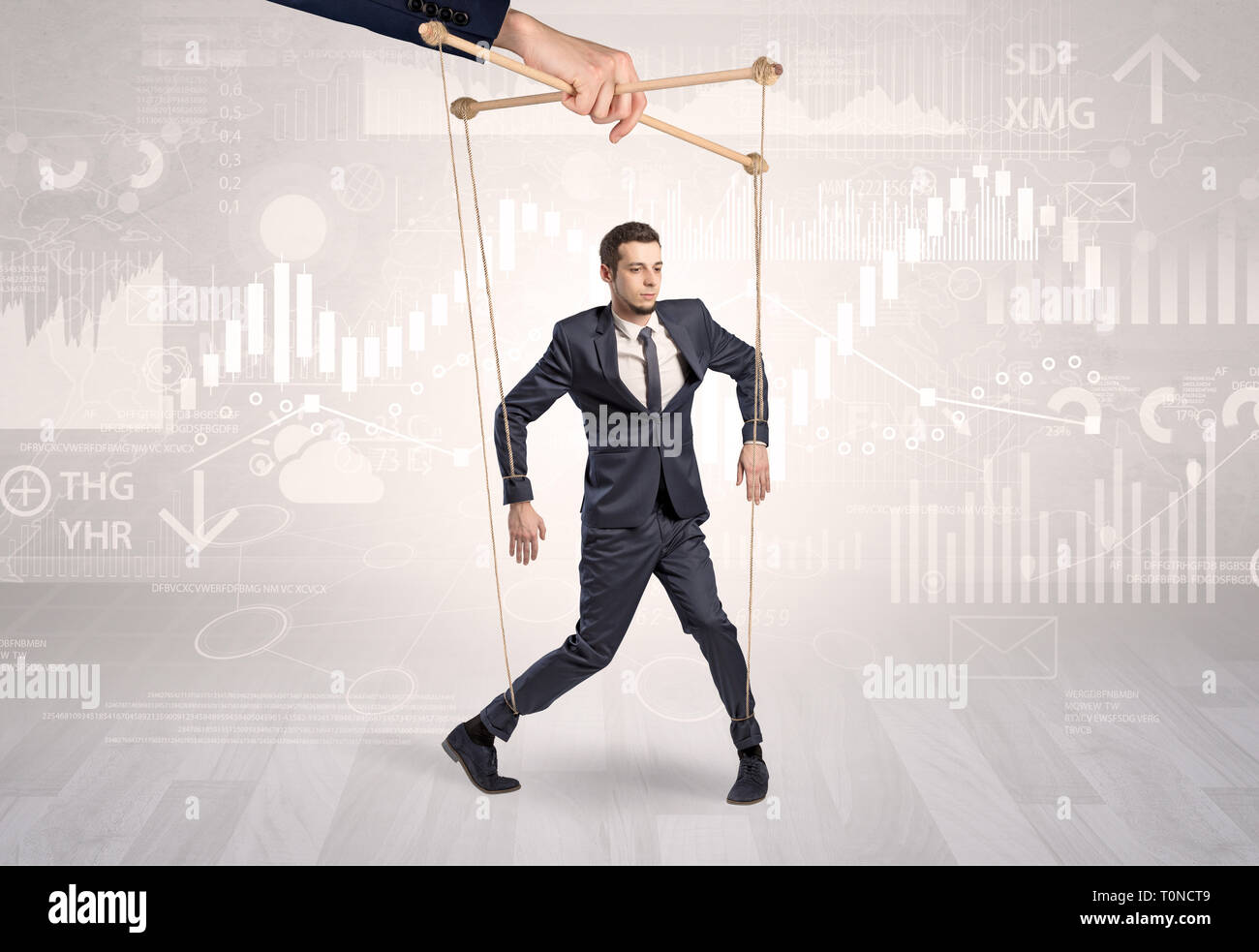 Puppet businessman controlled by another hand with financial concept ...