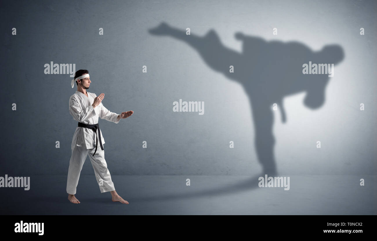 Young karate man confronting with his own shadow Stock Photo - Alamy