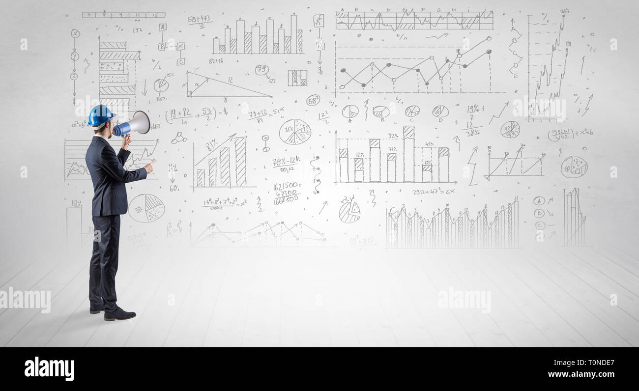 Engineer with construction helmet holding a plan and standing with ...