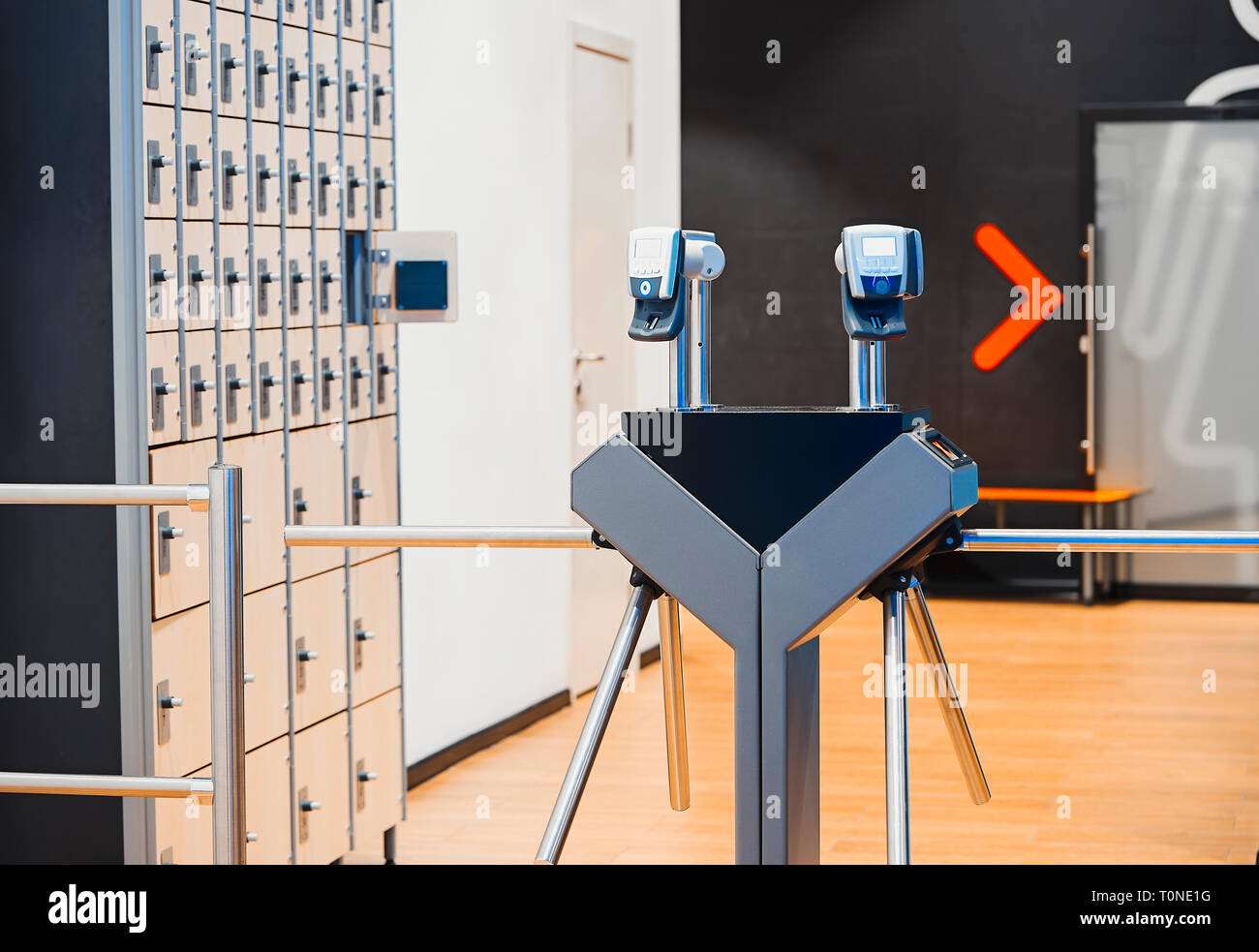 Fingerprint scanners at the entrance in modern bright gym and wooden ...