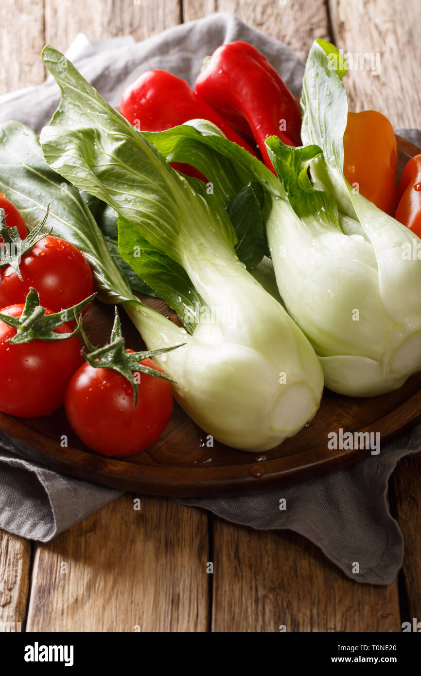 Fresh ingredients baby bok choy, tomatoes and peppers close-up on a ...