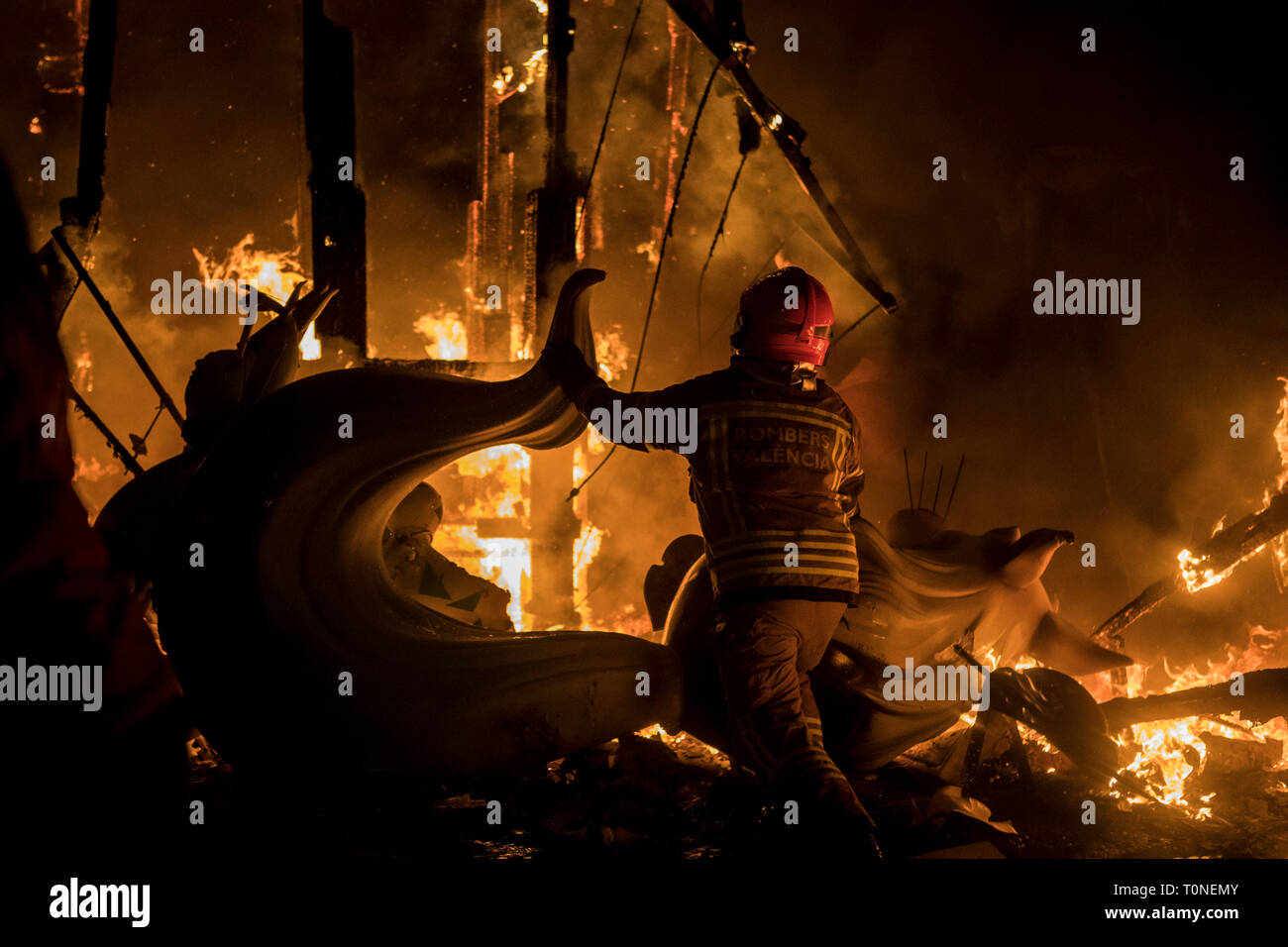 Fireman seen controlling the fire of the Falla during the event. On the ...