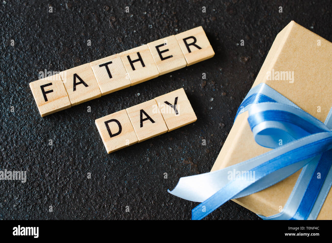 Happy Father's day greeting card with decorated gift box on dark ...