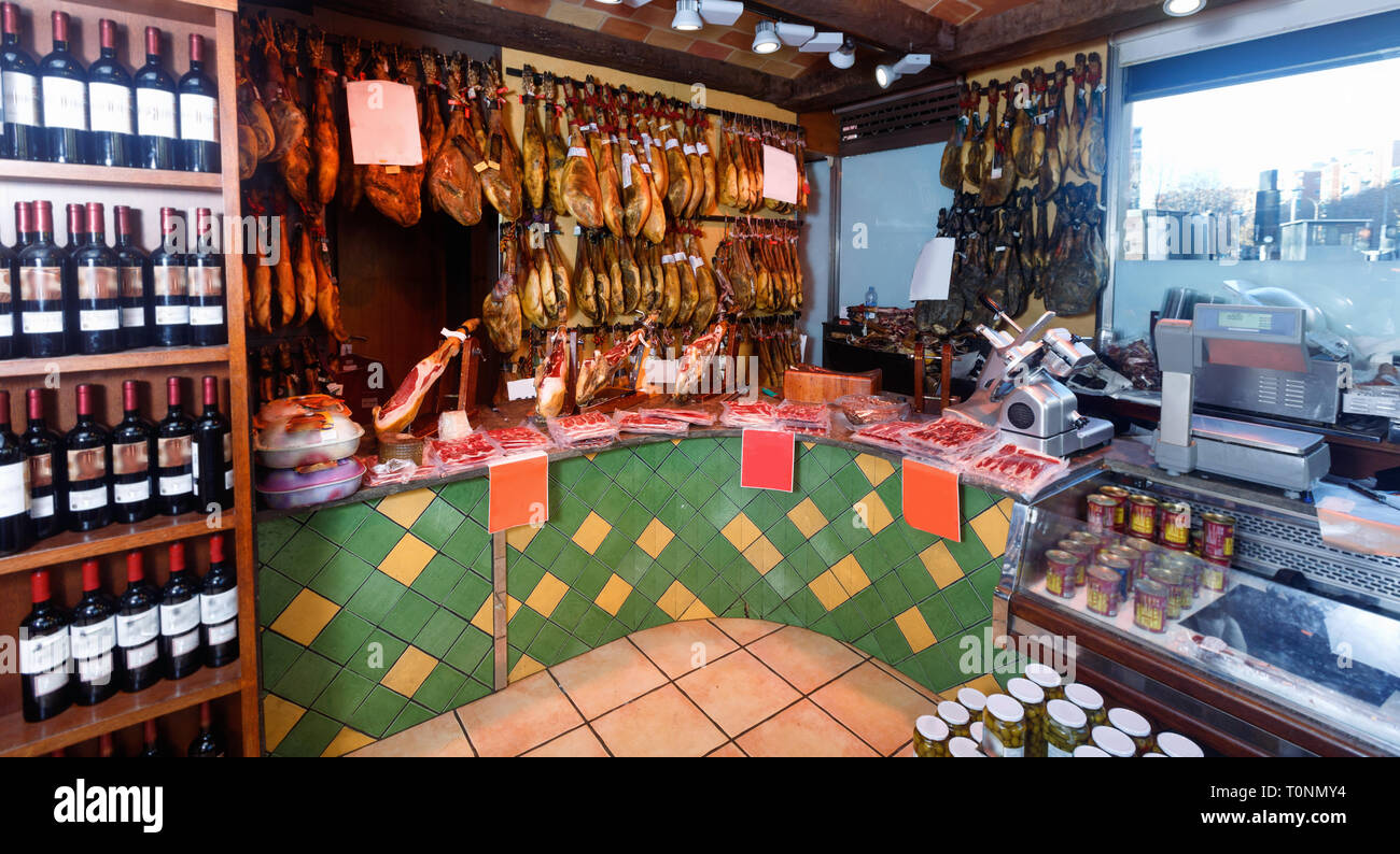 Assortment of traditional appetizing Spanish meat shop with dangling ...