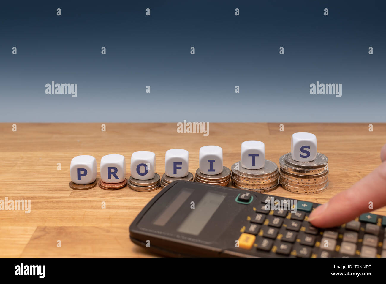 Symbol for increasing profits. Dice placed on stacks of coins form the ...
