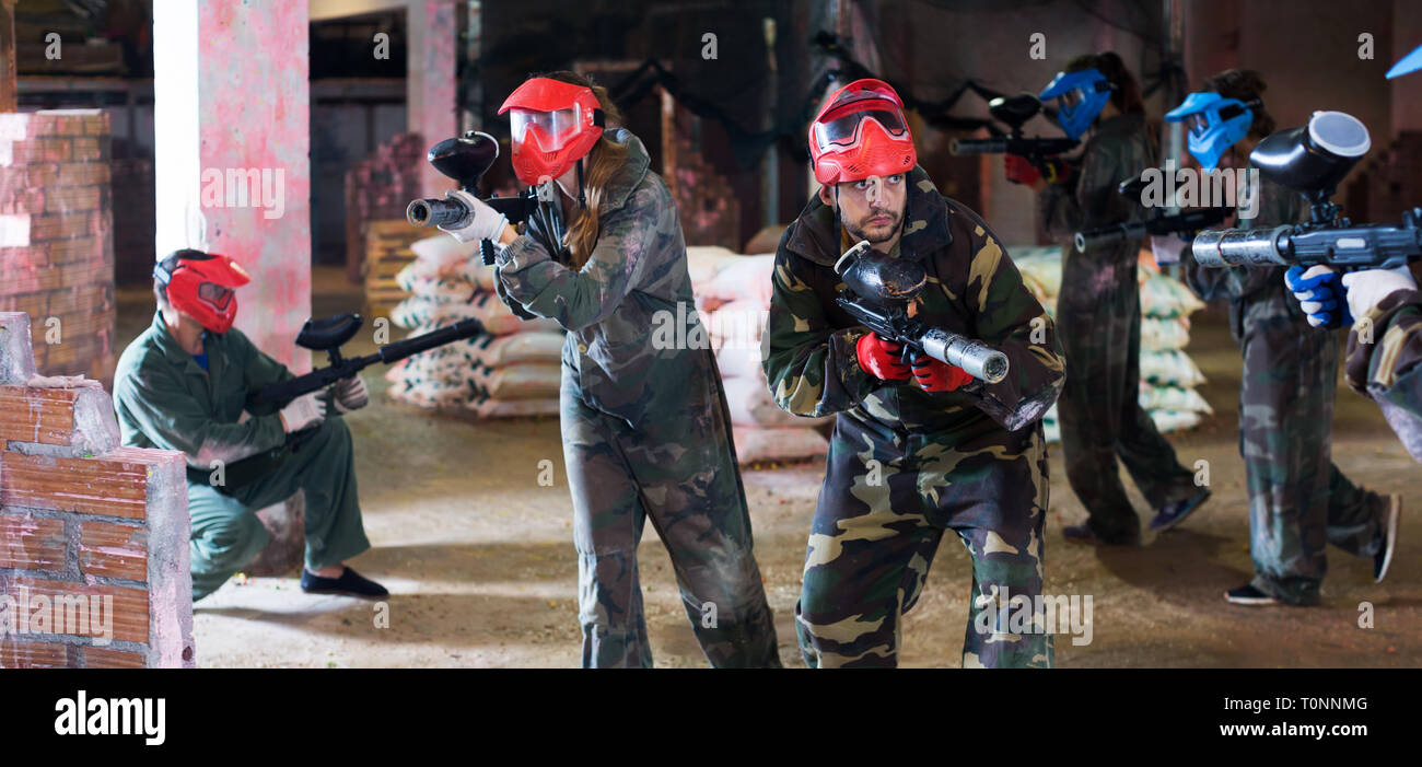Red team of young people are ready for battle in paintball club Stock ...