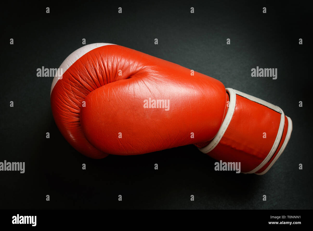 Old and used boxing glove on dark background Stock Photo - Alamy