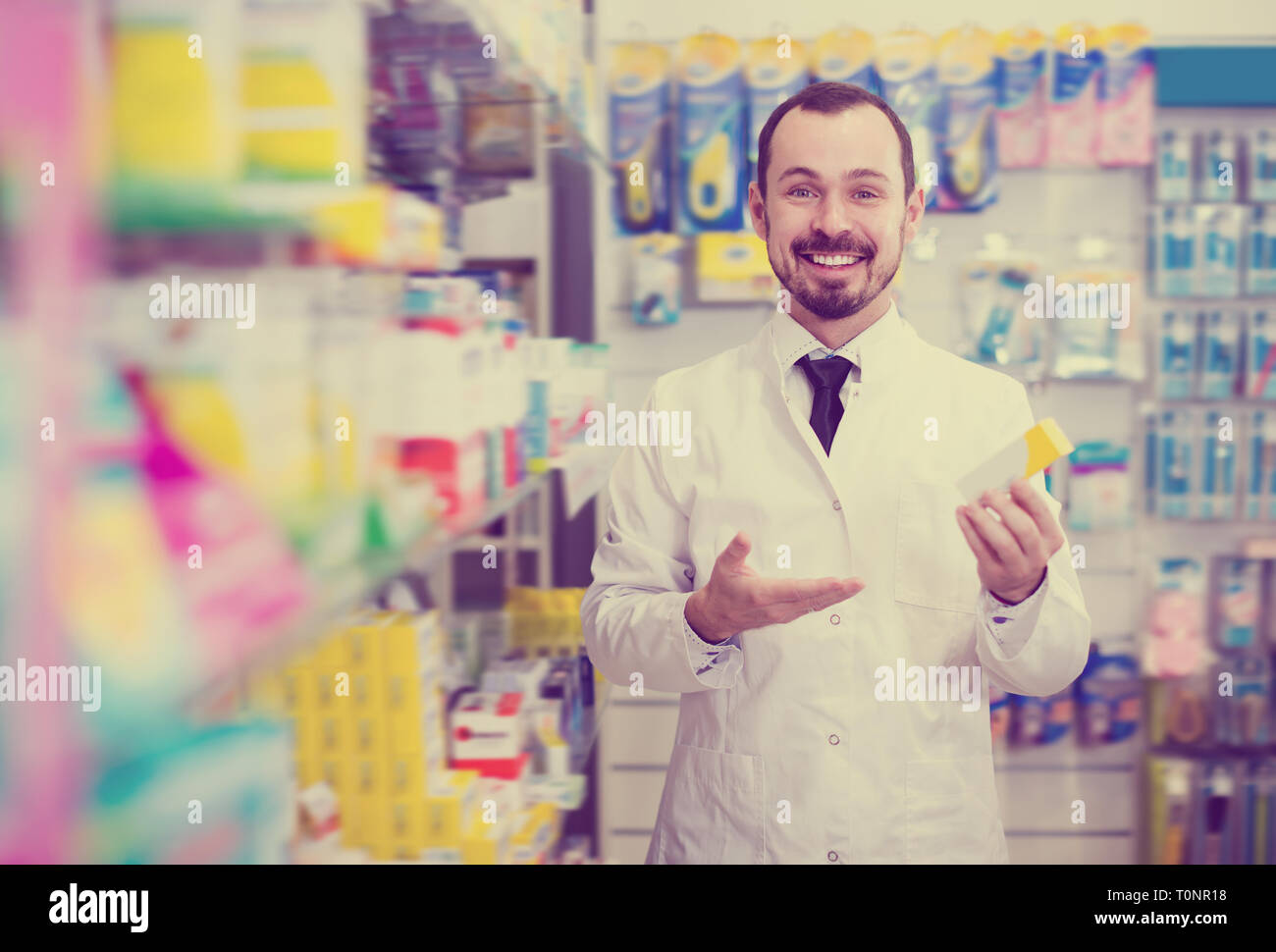 Happy male pharmacist suggesting useful drug in pharmacy Stock Photo ...