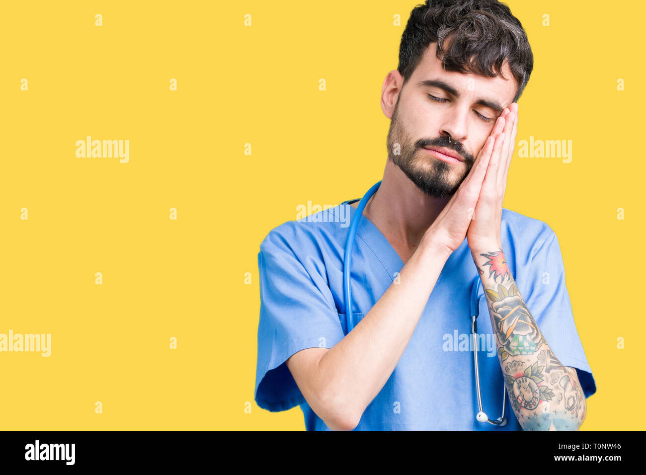 Young handsome nurse man wearing surgeon uniform over isolated ...