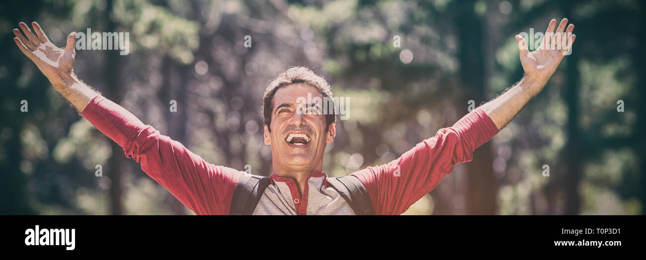 Man smiling and throwing up arms Stock Photo - Alamy