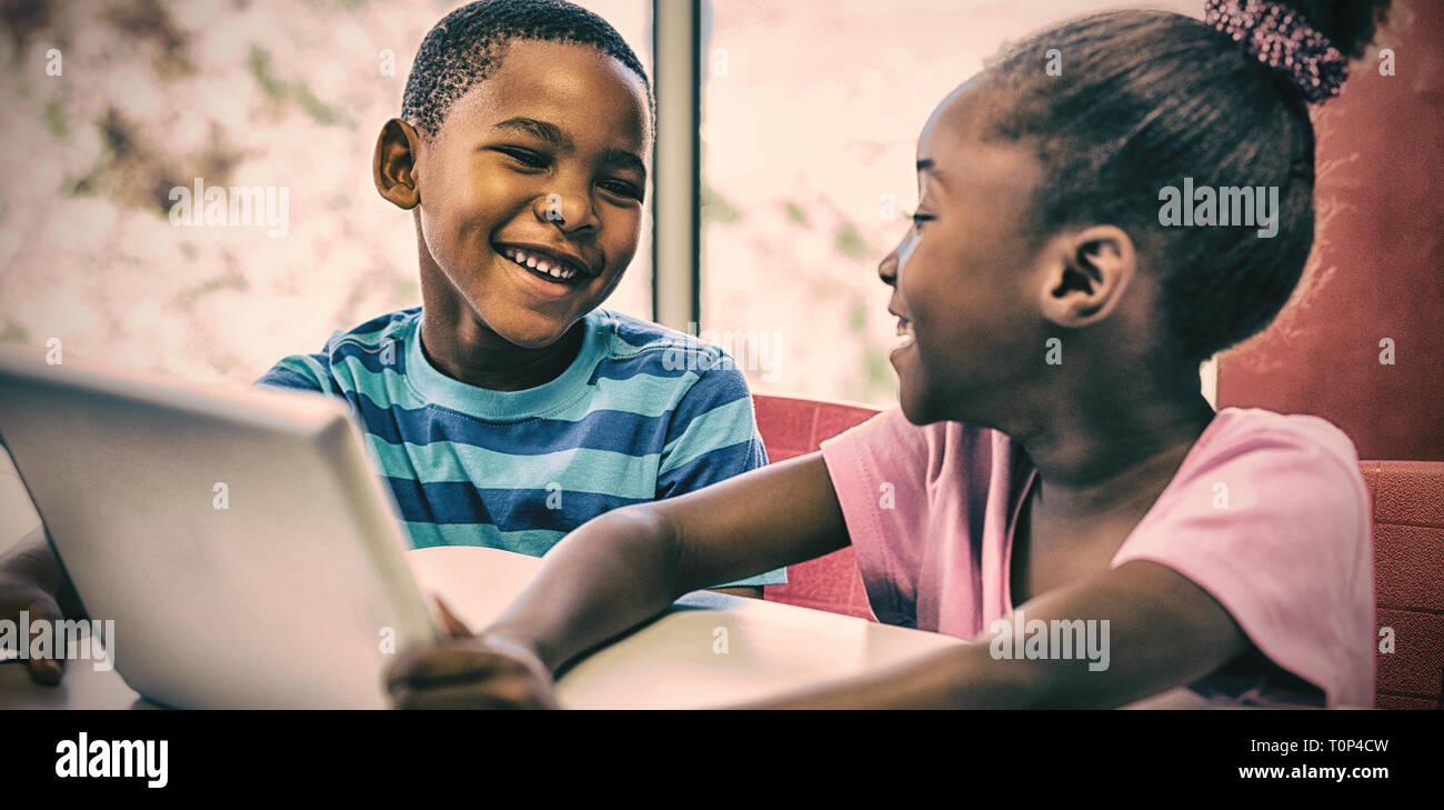 Children using digital tablet in classroom Stock Photo - Alamy